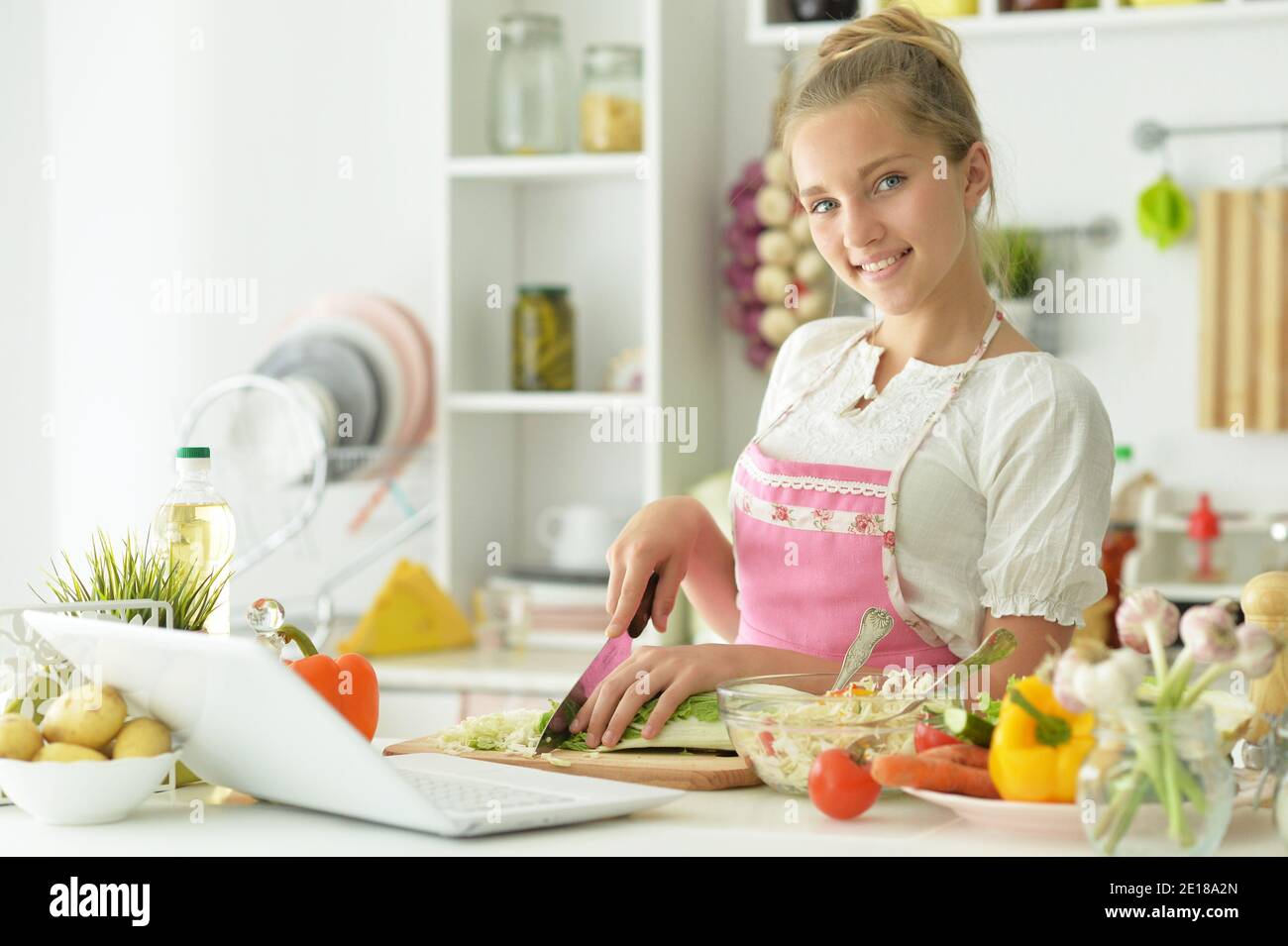 Portrait of cute girl cooking on kitchen Stock Photo - Alamy