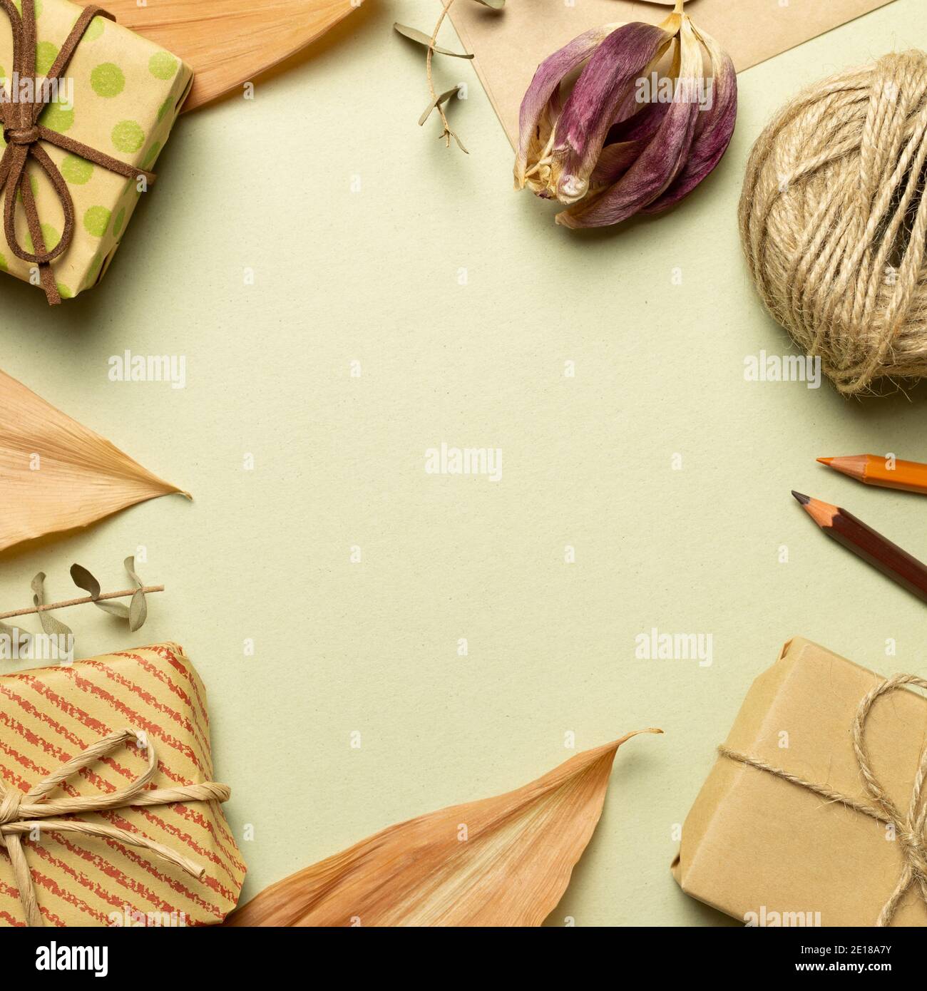 Anniversary concept. Gift boxes with dry leaves on khaki background ...