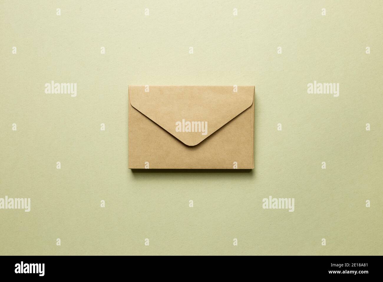Kraft brown paper envelope on khaki background. top view, copy space ...