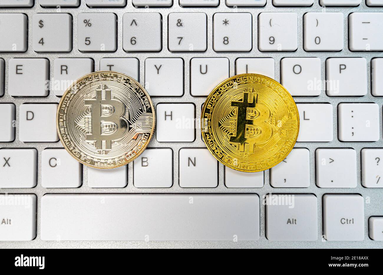 Bitcoins silver and gold color on keyboard. New Virtual money concept ...
