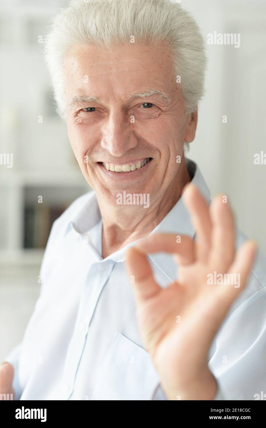 Good old man showing ok at homen Stock Photo - Alamy