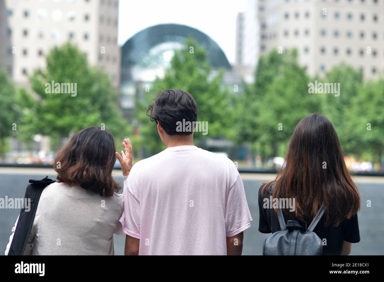 Back view of three people standing on street Stock Photo - Alamy