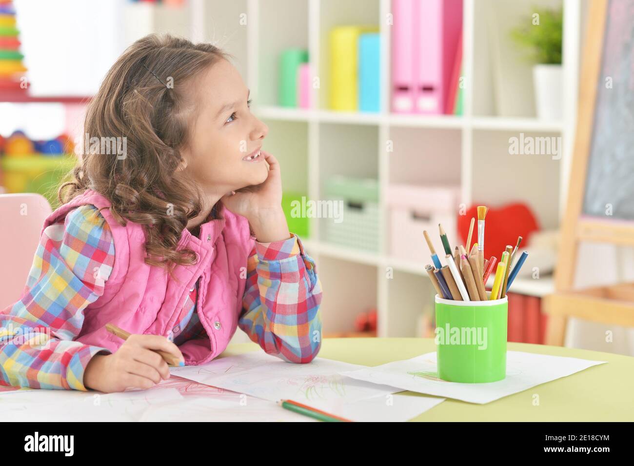 Cute beautiful smiling girl drawing at home Stock Photo - Alamy