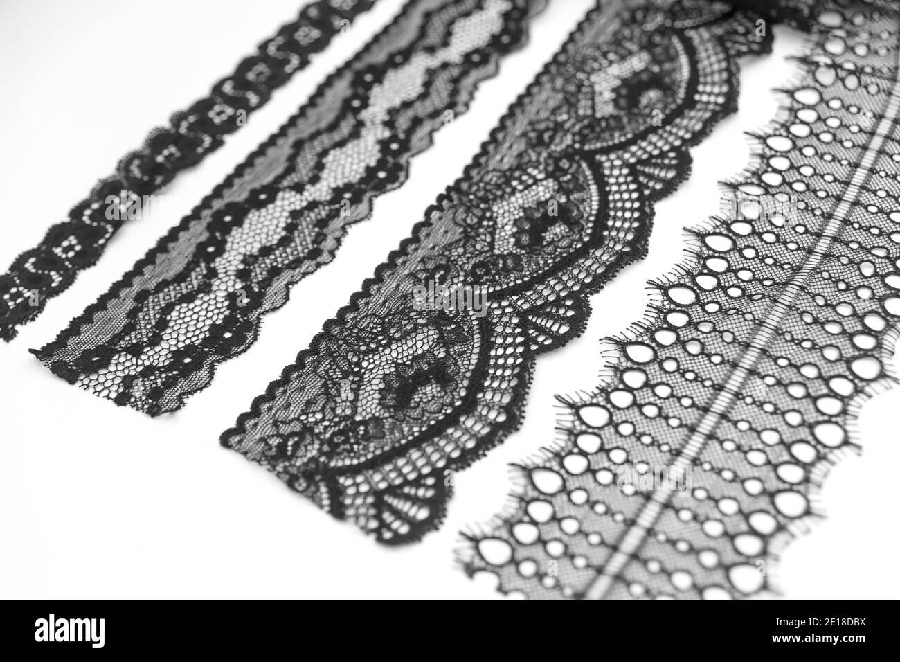 No brand black color lace samples on white background Stock Photo - Alamy