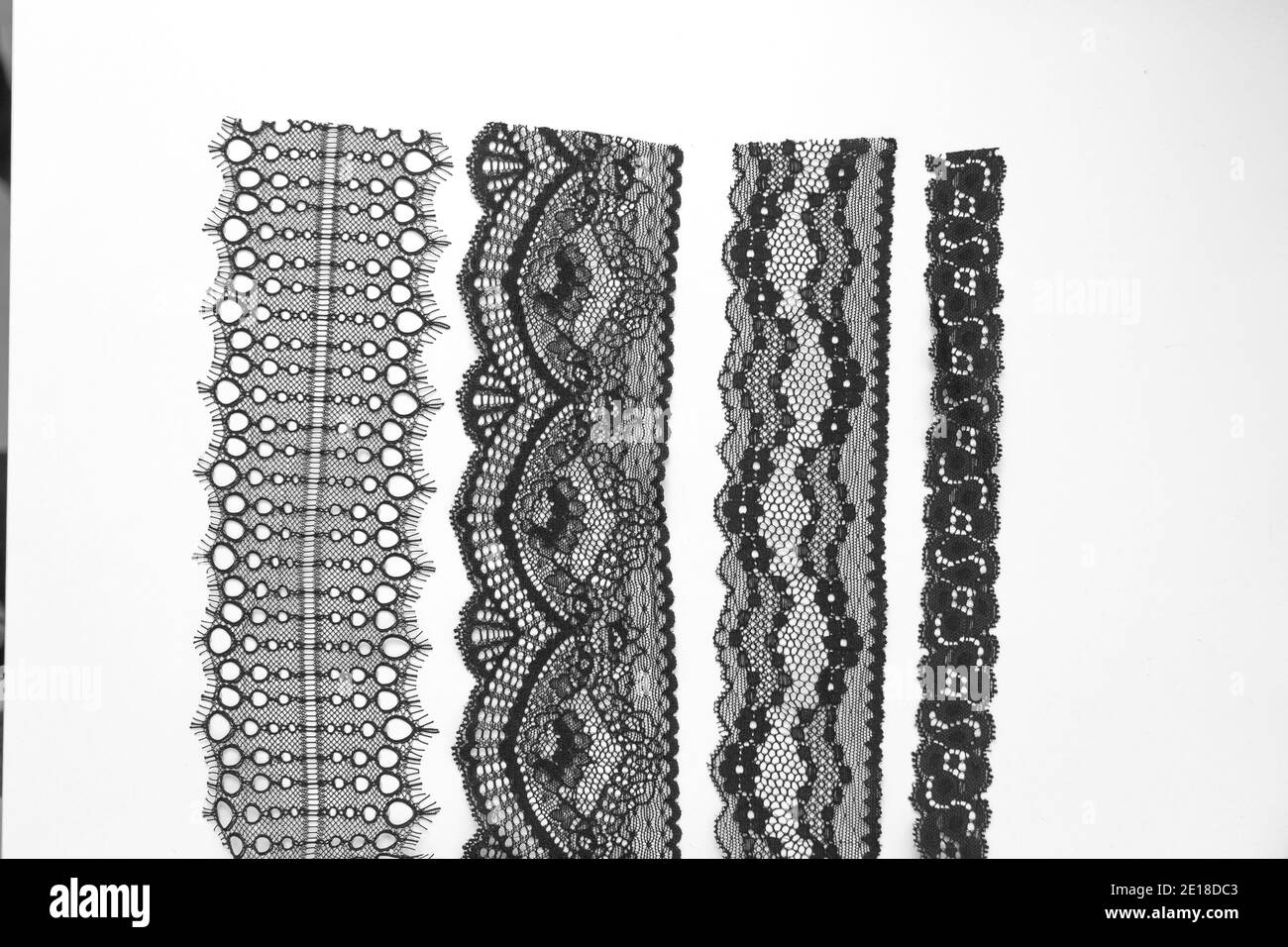 No brand black color lace samples on white background Stock Photo - Alamy