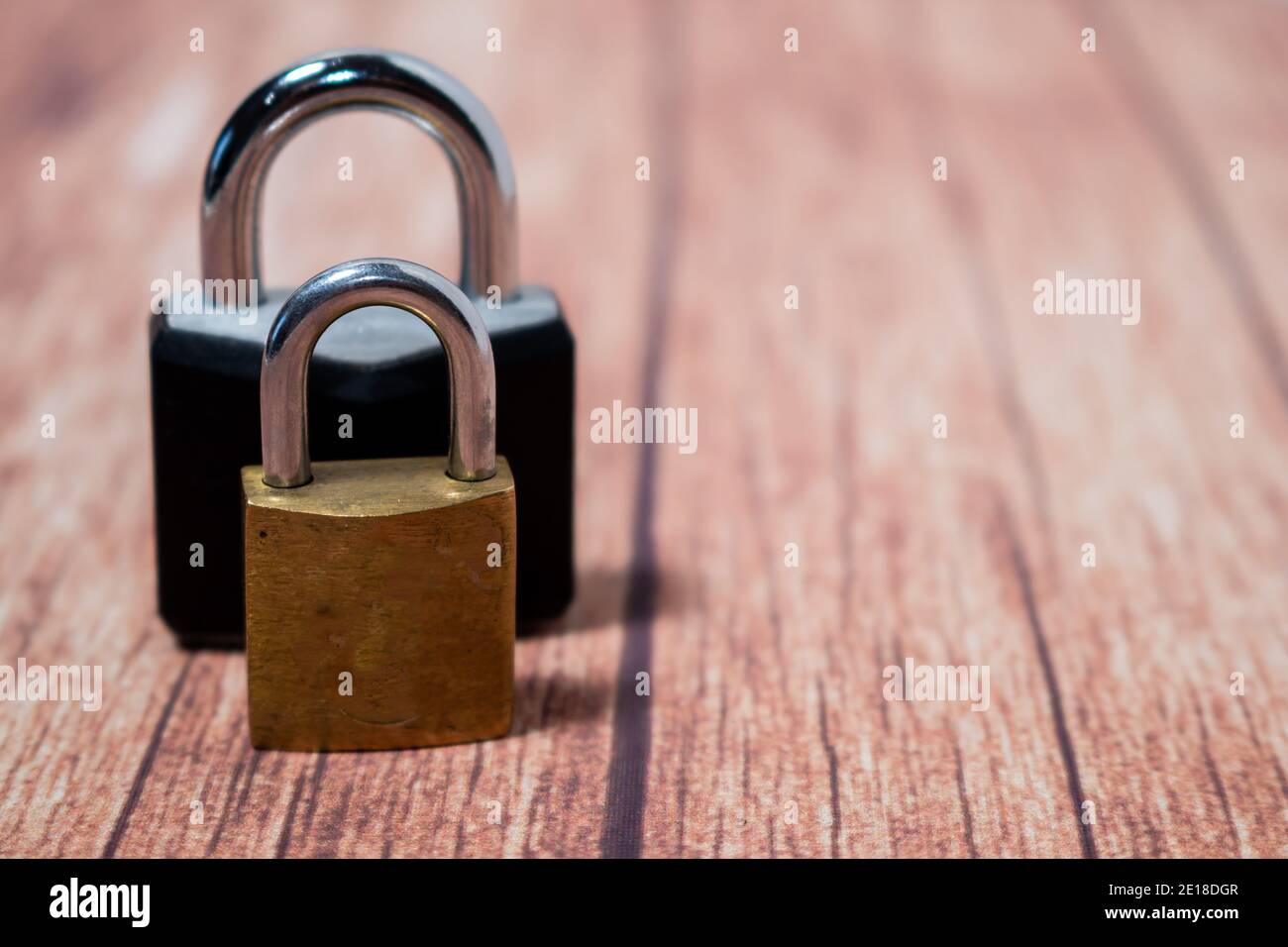 Classic golden bronze padlock and black steel and iron padlock Stock ...