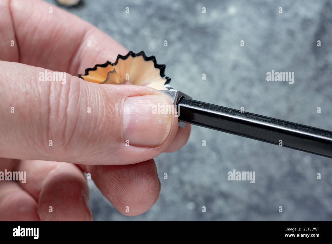 Hands performing the action of sharpening a pencil with a standard ...