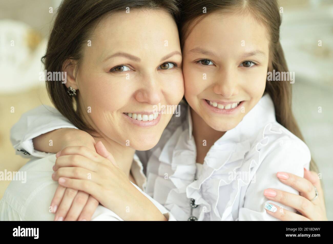 Beautiful young mother and cute little daughter posing Stock Photo - Alamy