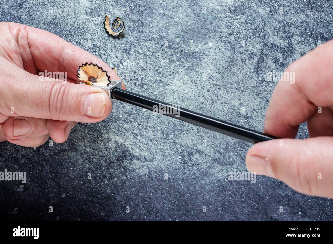 Hands performing the action of sharpening a pencil with a standard ...