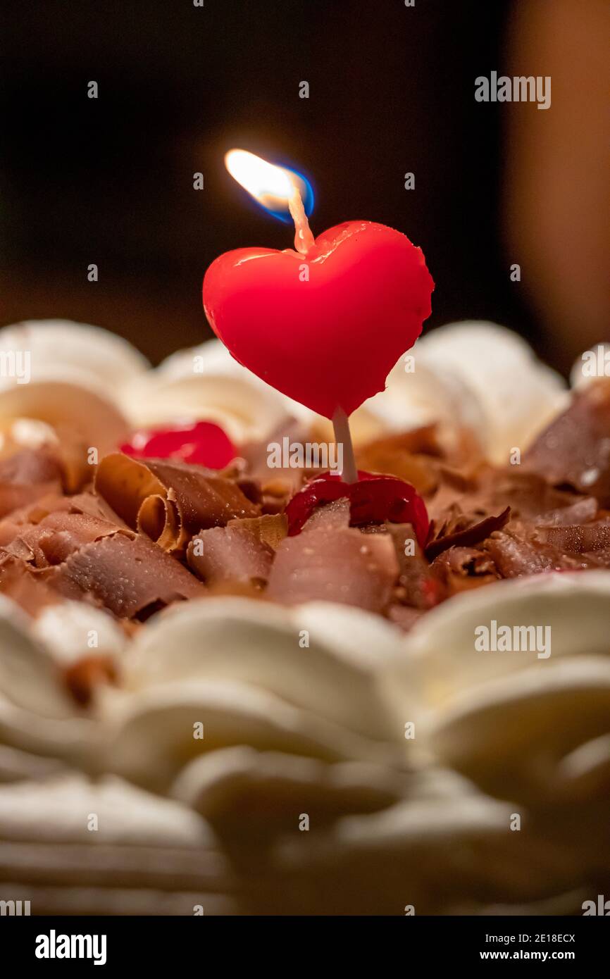 Birthday celebration cake closeup with hearth shaped candle Stock Photo ...