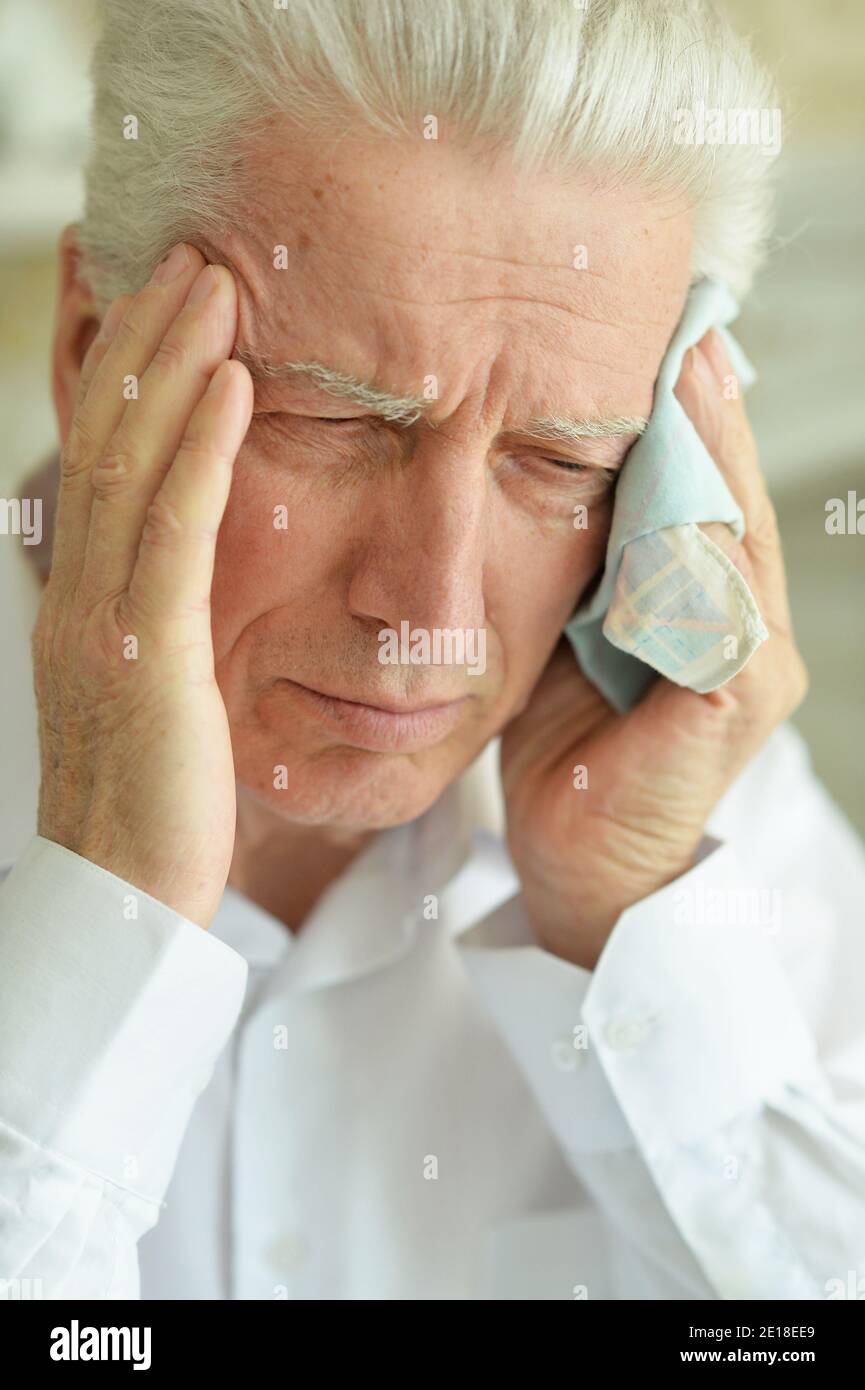 Portrait of sad sick senior man with headache Stock Photo - Alamy