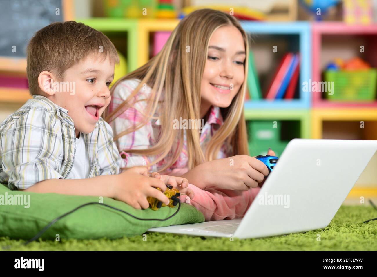 Portrait of brother and sister playing computer Stock Photo - Alamy