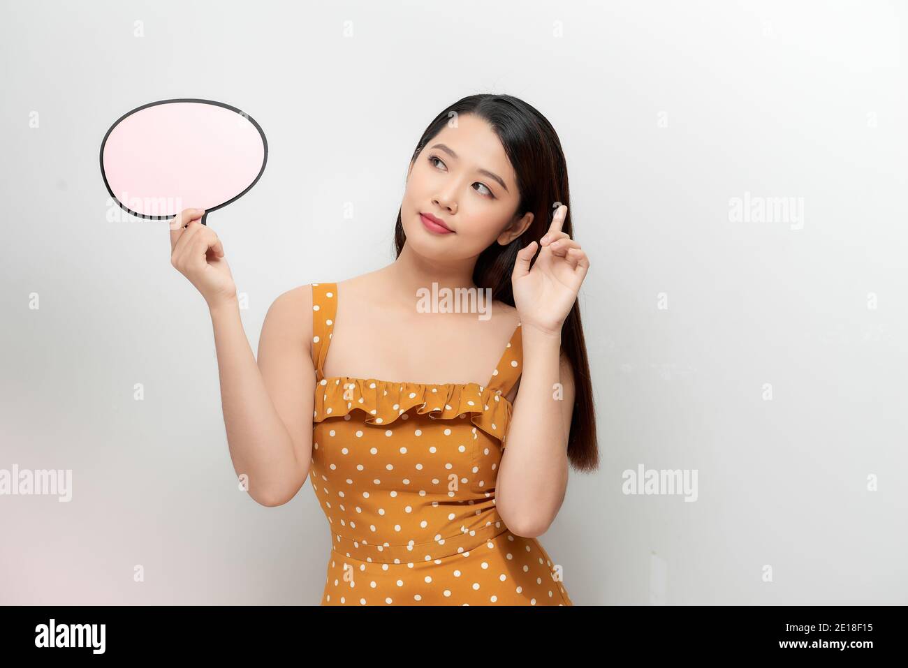 Attractive asian female with empty message box isolated on white ...