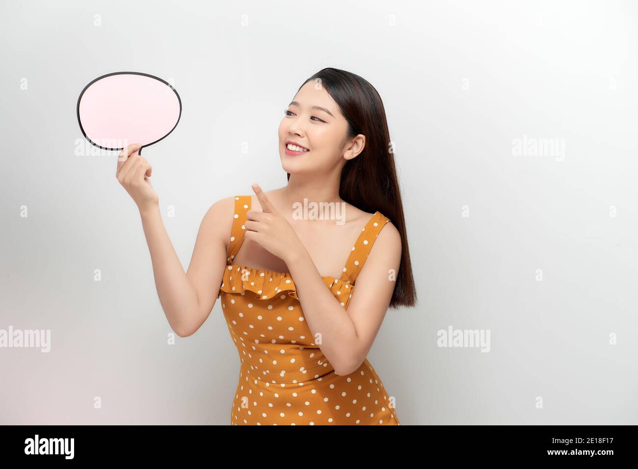 Attractive asian female with empty message box isolated on white ...