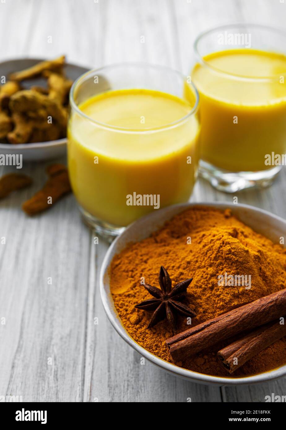 Yellow turmeric latte drink. Golden milk with cinnamon, turmeric ...
