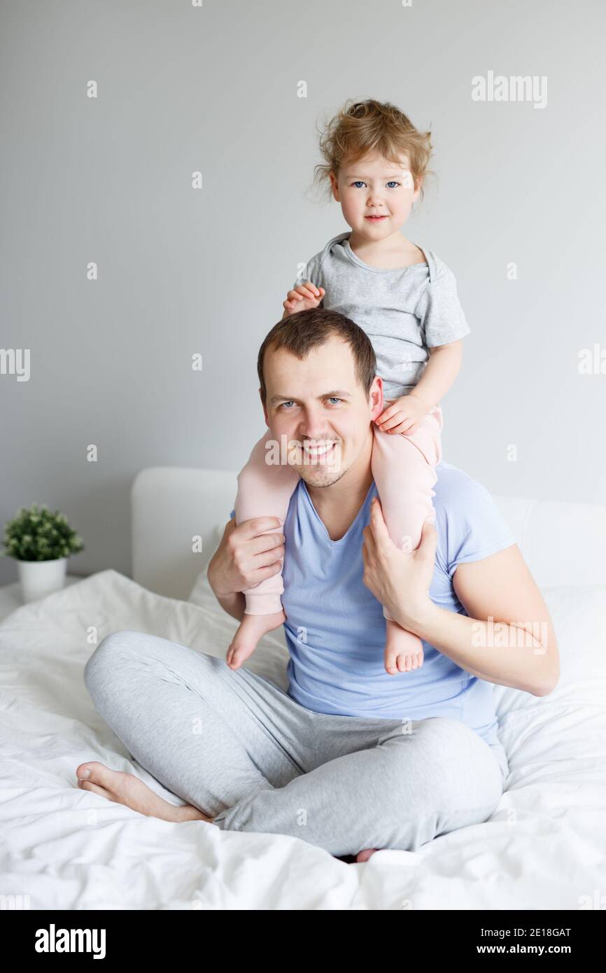 family, love and fatherhood concept - portrait of happy father and cute ...