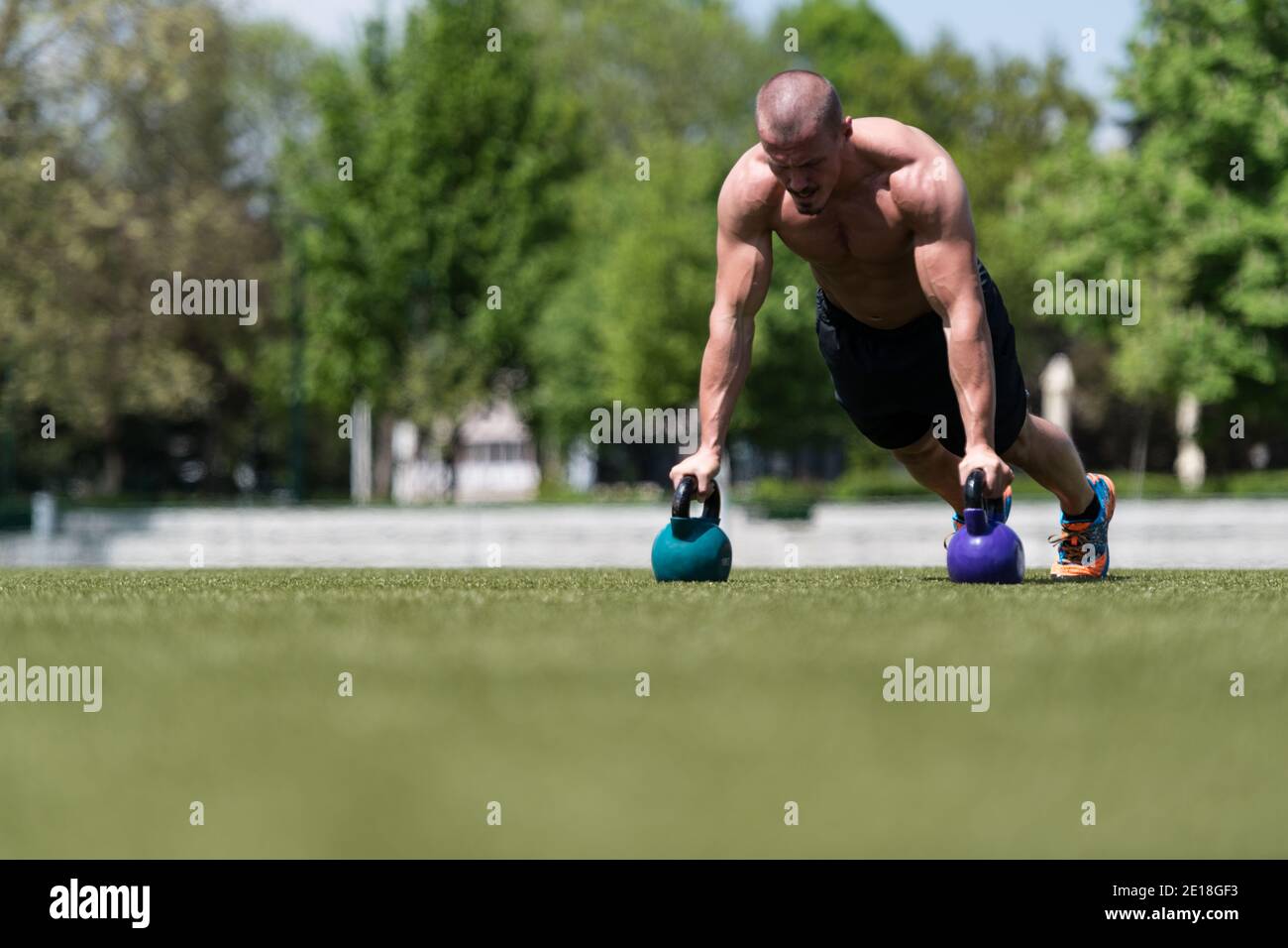 Healthy Man Athlete Doing Pushups Workout With Kettle Bell Outdoor ...