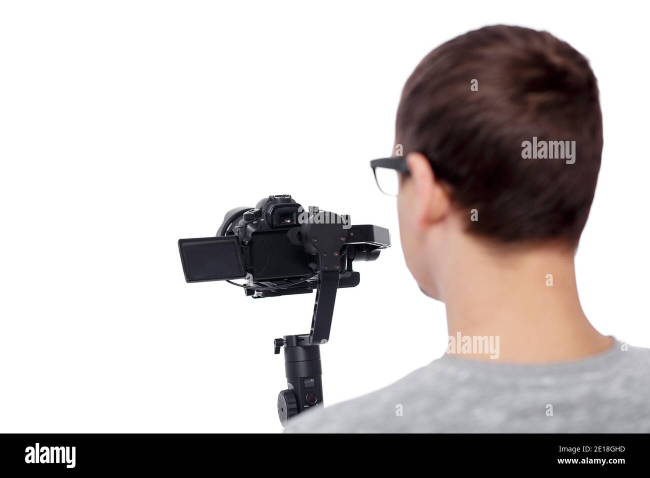 back view of professional videographer shooting video with dslr camera ...