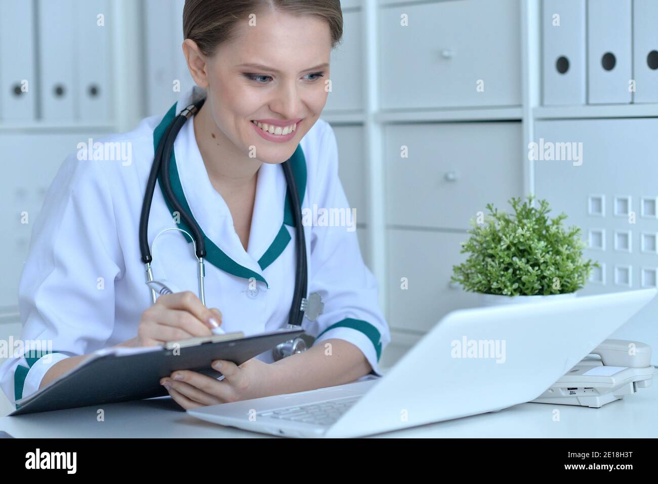 Young smart female doctor computer hi-res stock photography and images ...