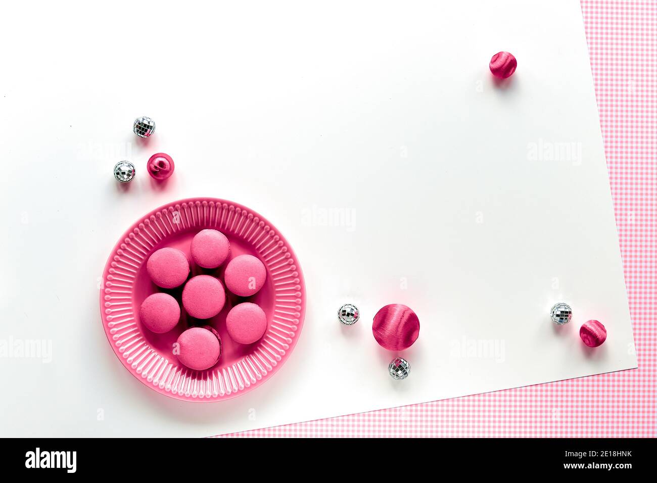 Pink macaroons on a plate. Simple monochrome flat lay on split two tone ...