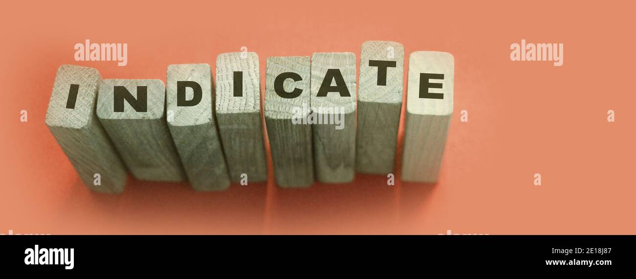 Indicate word on wooden blocks on cyan background. Financial indicator ...