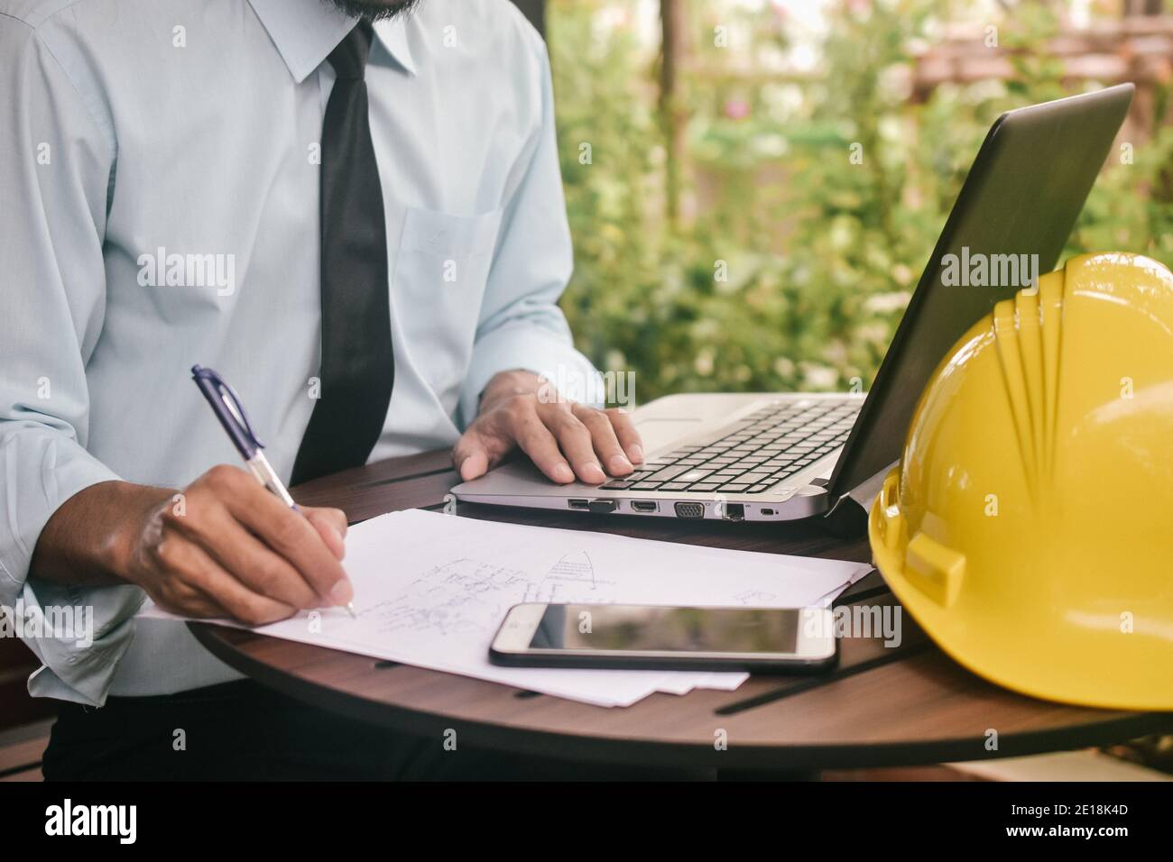 Businessman writing on paperwork computer notebook work in office Stock ...