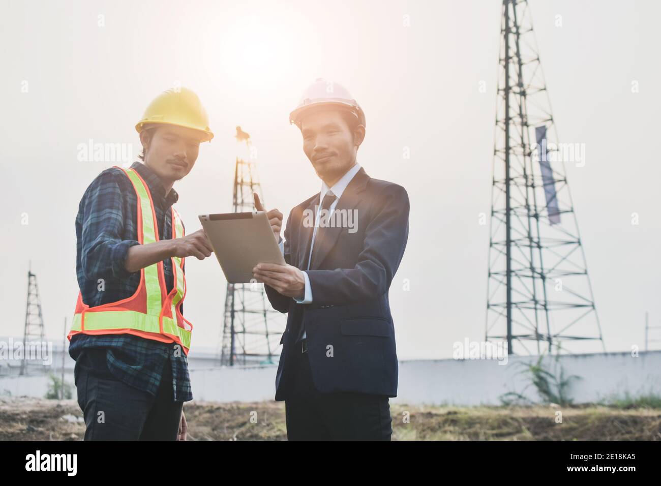 Project manager holding tablet communication with Construction ...