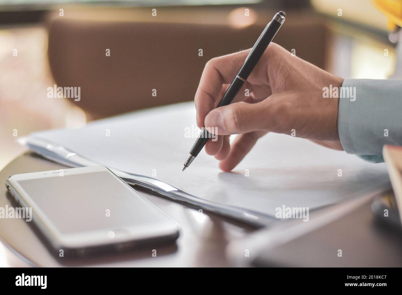 Businessman holding pen writing on paper document working,Close up hand ...