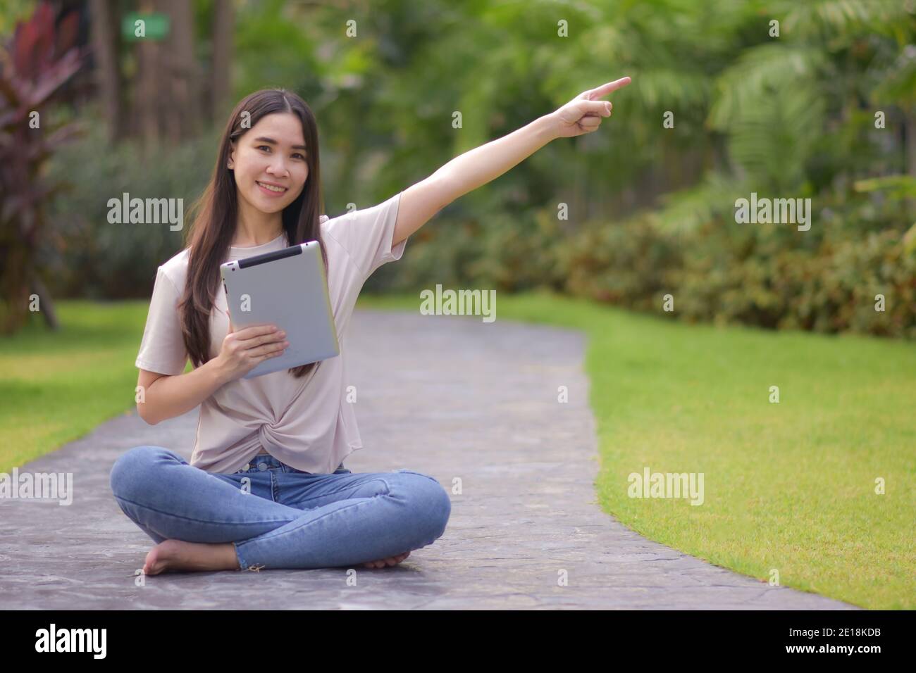 Beauty Asian Women using tablet,Girl use internet mobile on tablet ...