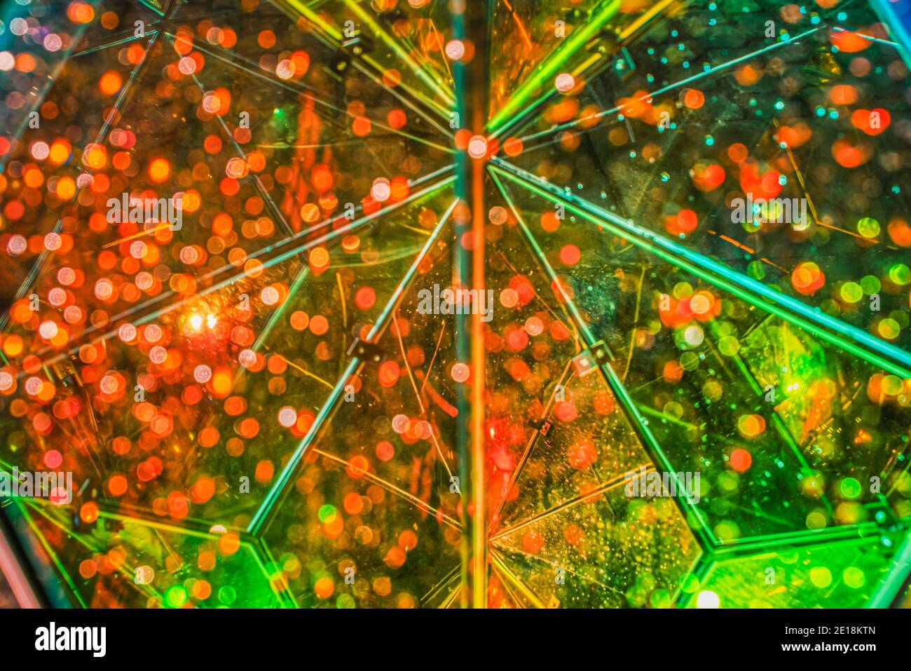 Rain drops lying on glass with green and red lights creates a romantic ...