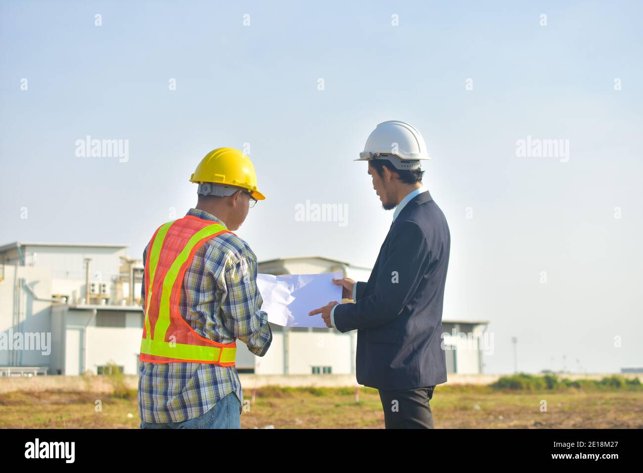 Project Manager taking with Engineer construction plan project building ...