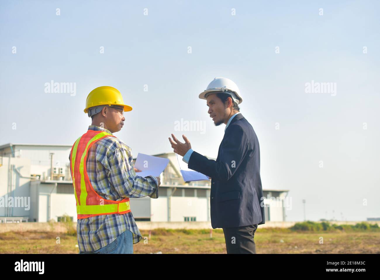 Project Manager taking with Engineer construction plan project building ...