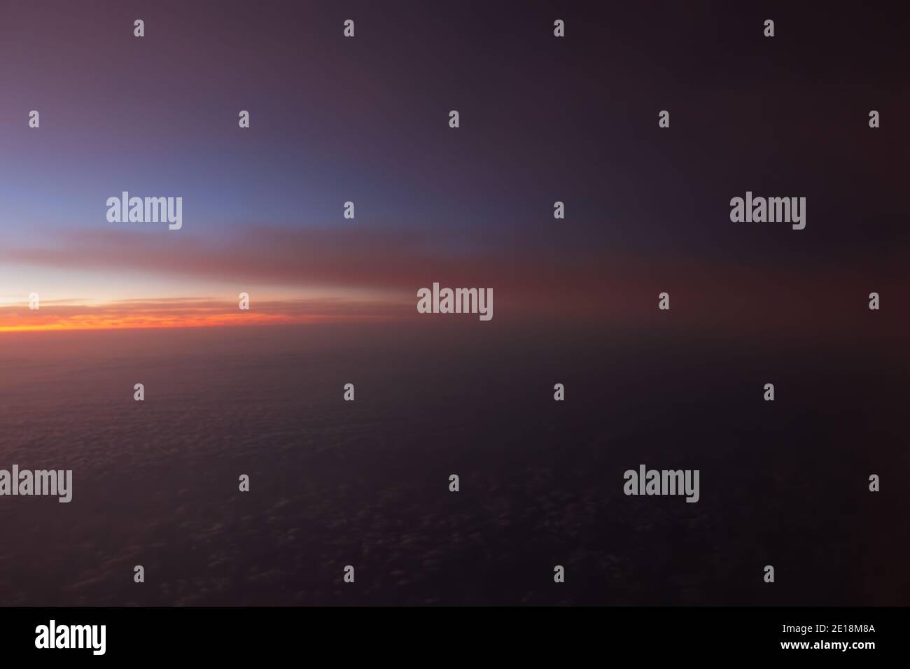 Colorful hues of a dramatic sunrise captured from a flight Stock Photo ...