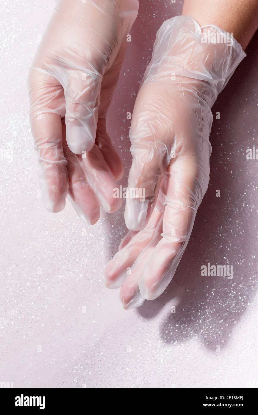 woman hands wearing transparent disposable plastic glove on white ...