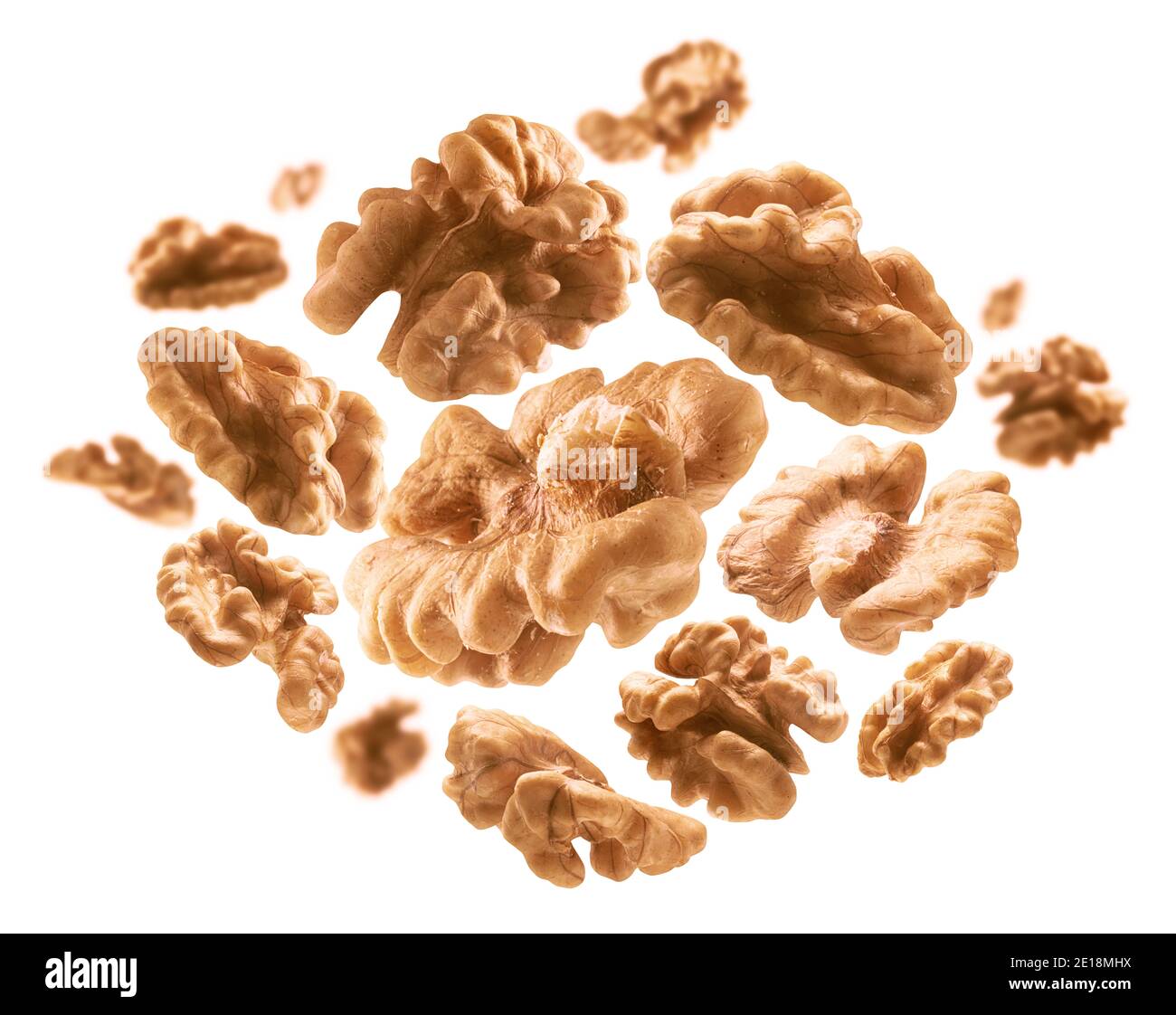 Peeled from the shell, walnut kernels levitate on a white background ...