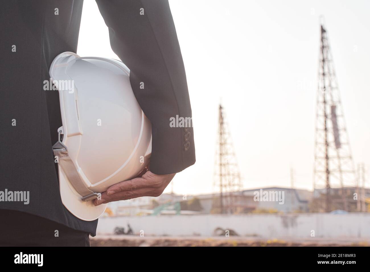 Manager holding helmet safety at building construction site Stock Photo ...