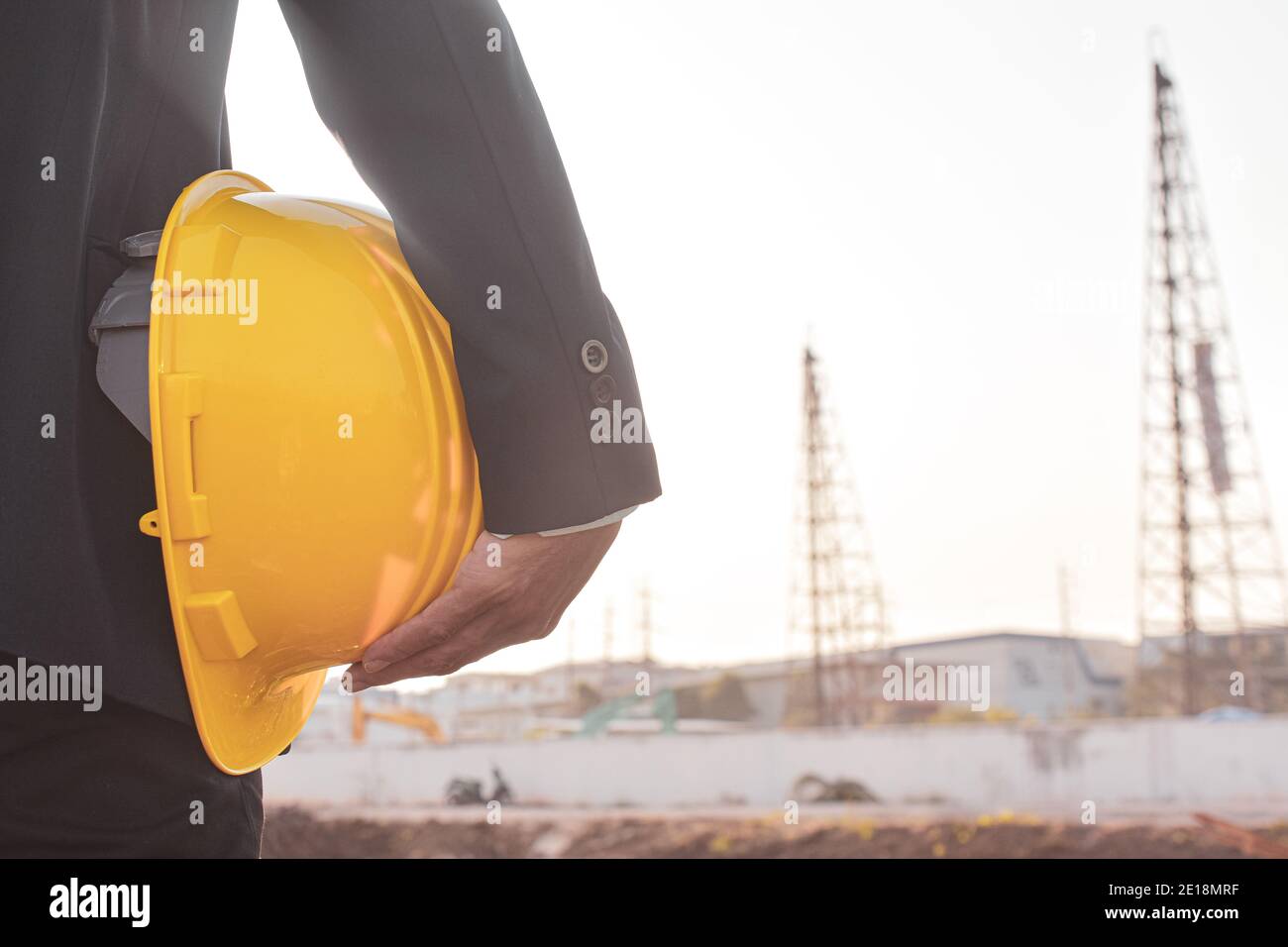 Manager holding helmet safety at building construction site Stock Photo ...