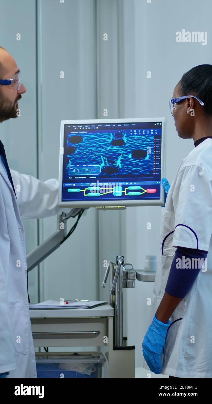 Team of multiethnic scientists working in laboratory analysing test ...