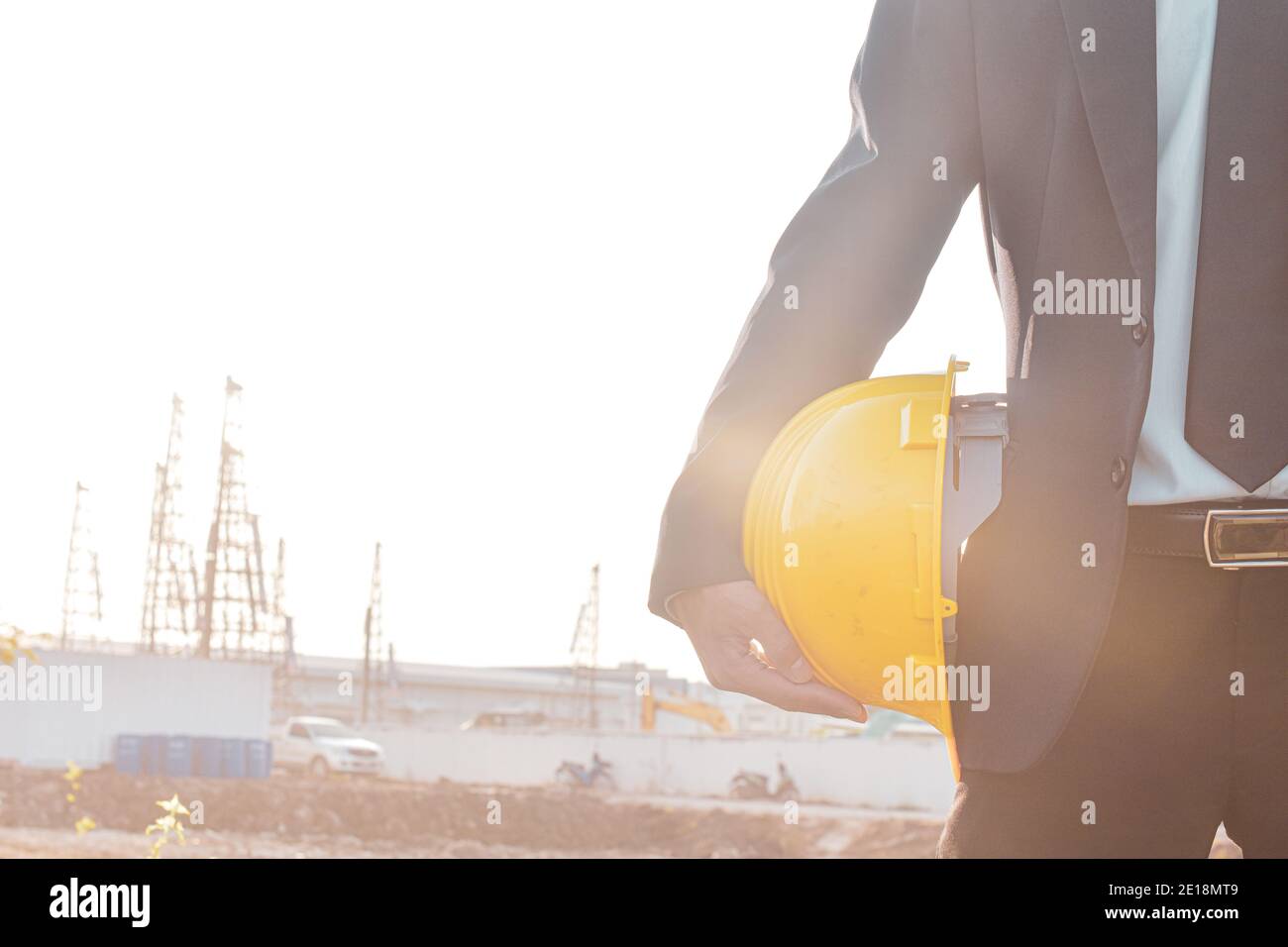 Manager holding helmet safety at building construction site Stock Photo ...