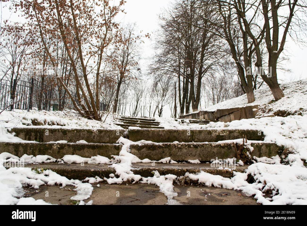Stone concrete snow covered stairs in the city at winter. Stairway to ...