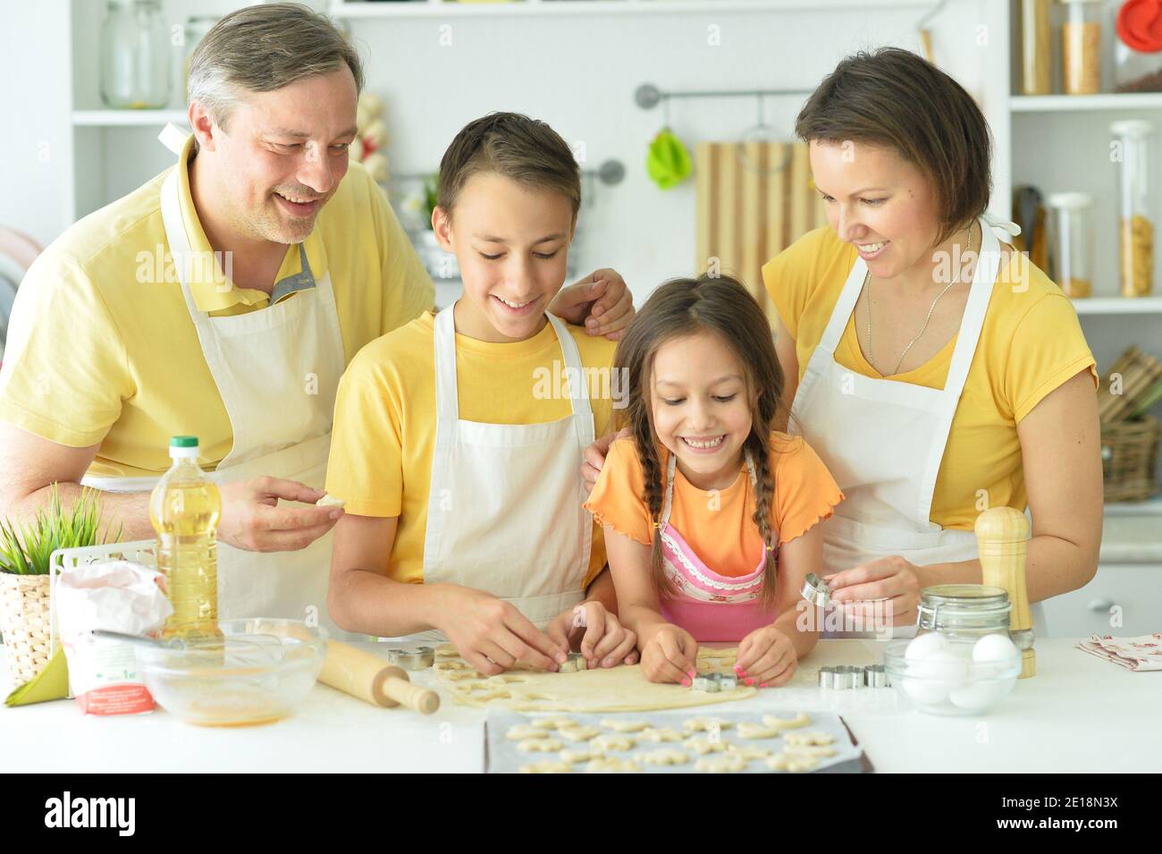 Happy family baking together in the kitchen Stock Photo - Alamy