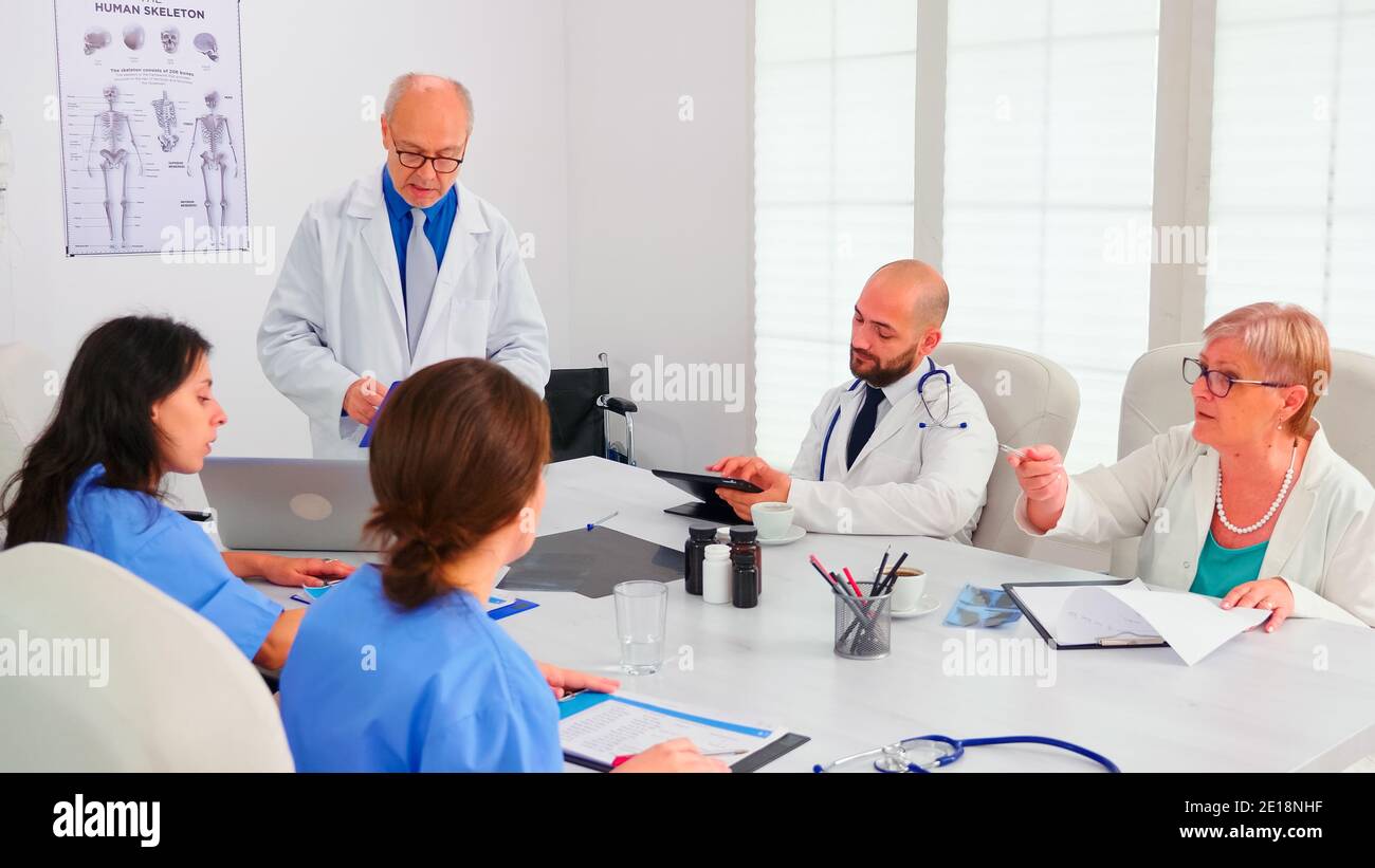 Expert doctor talking about medical technology with medical staff ...