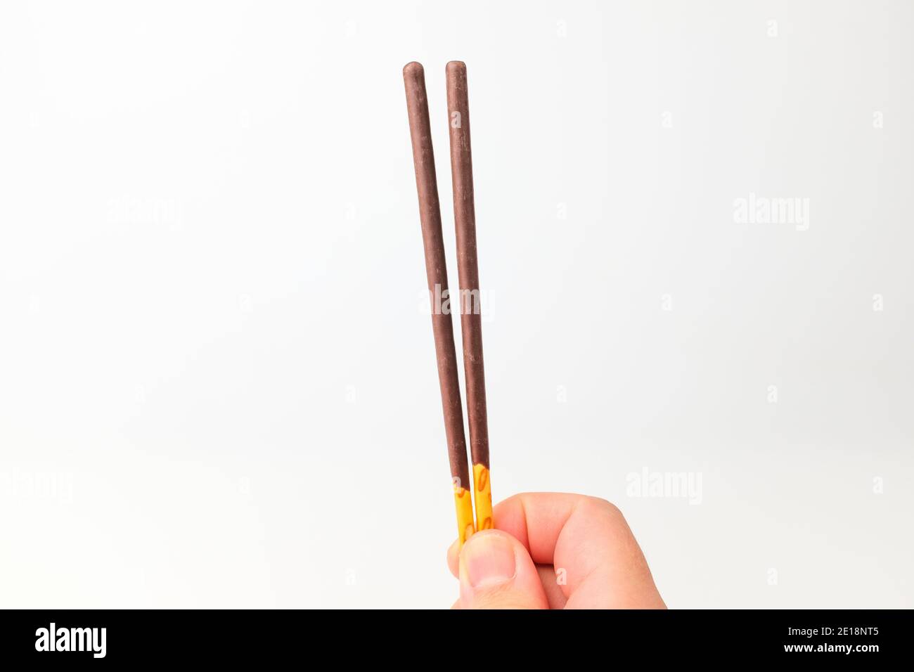 Chocolate sticks on white background Stock Photo - Alamy