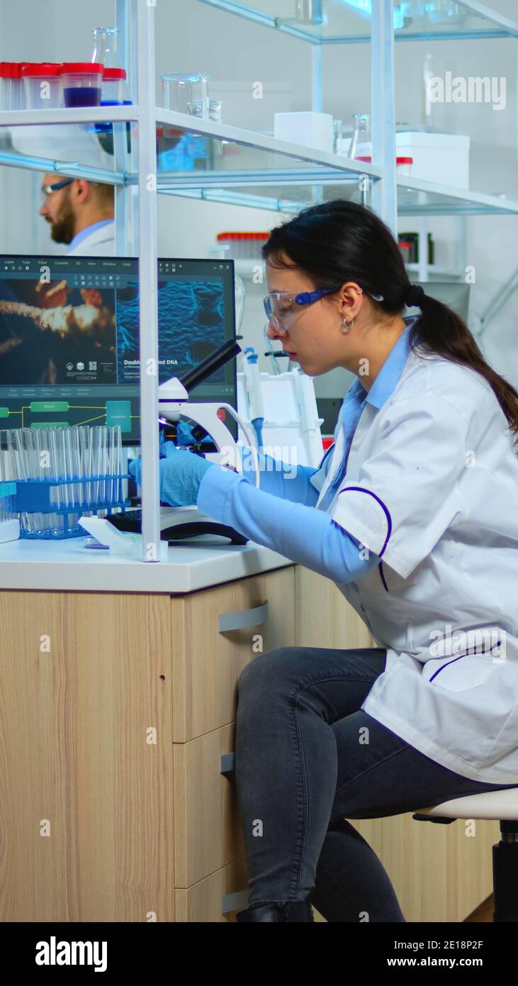 Microbiologist working for new vaccine in modern laboratory looking at ...