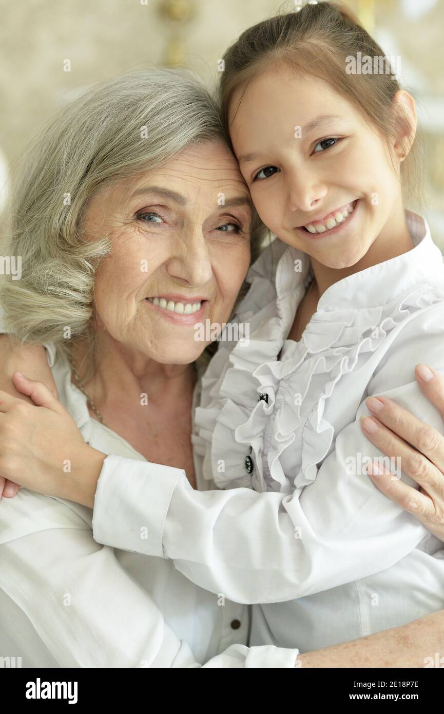 Portrait of grandmother with her cute granddaughter smiling Stock Photo ...