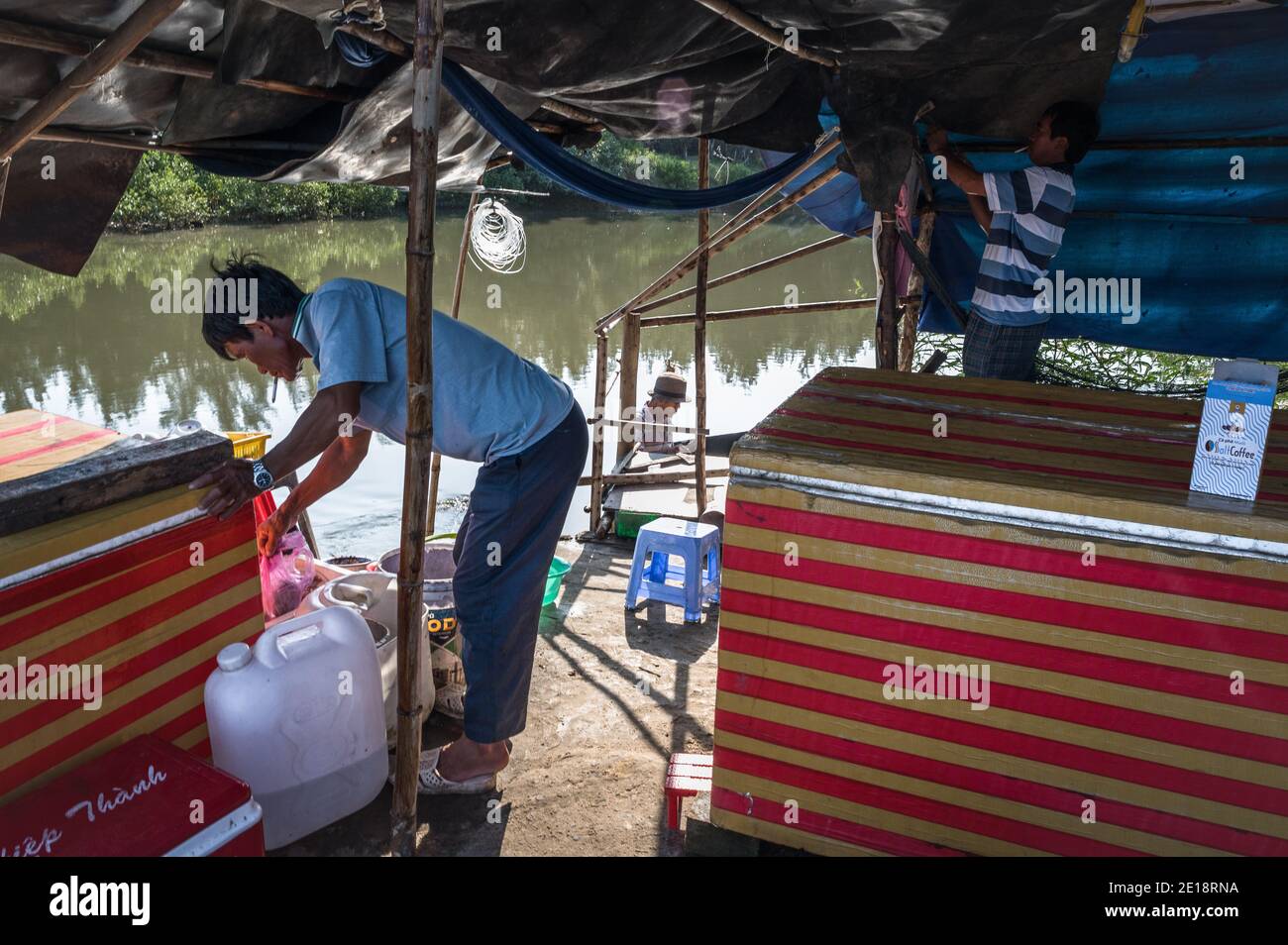 Men doing improvements at a refreshment stand in Can ca Loc An, Vietnam ...