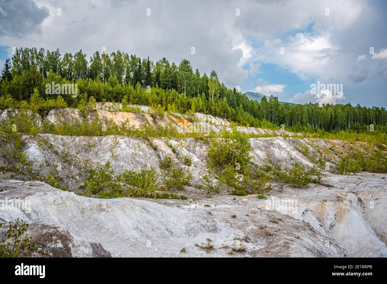 Abandoned talc quarry overgrown with trees and grass Stock Photo - Alamy
