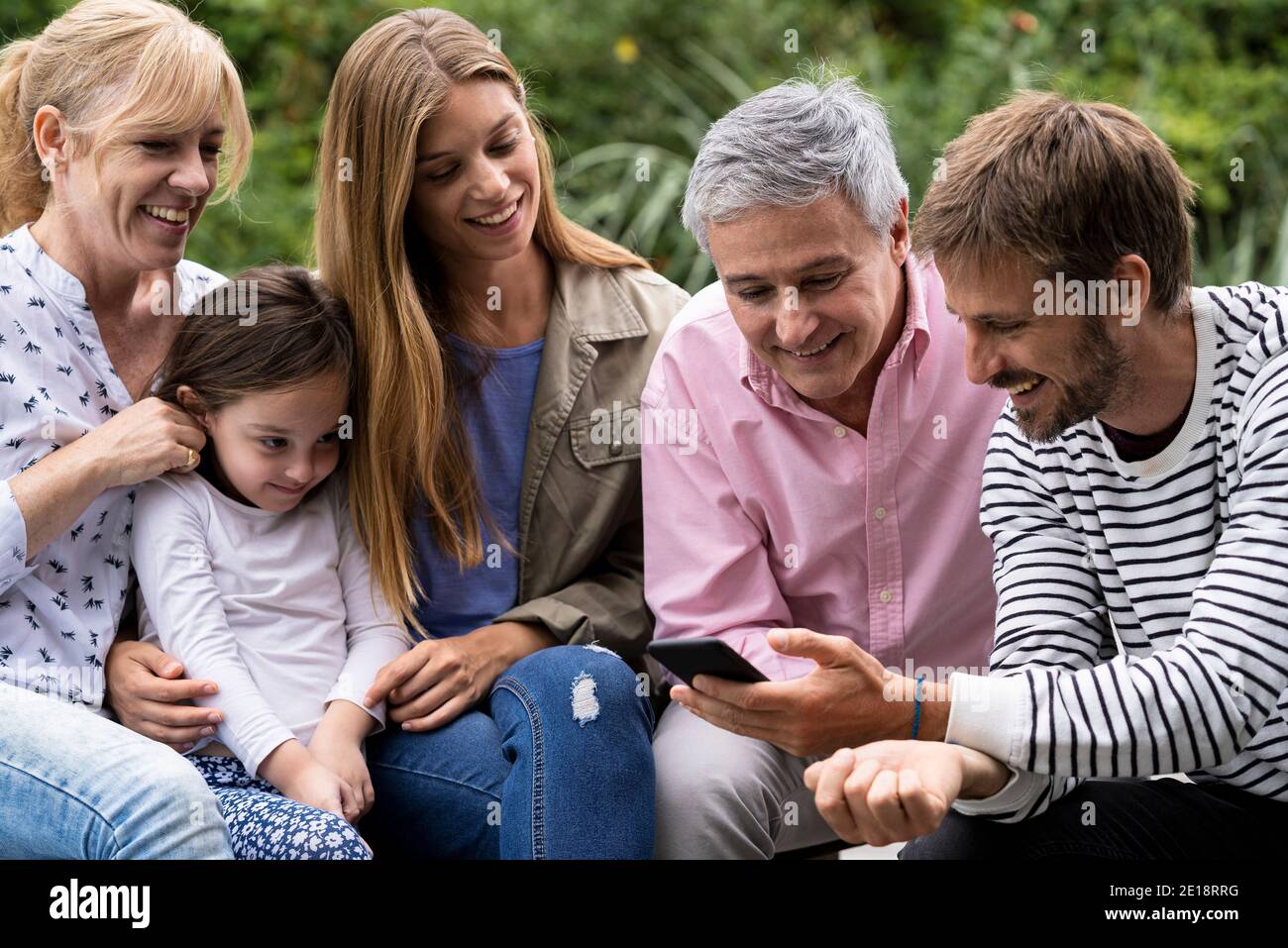 Family looking at smartphone Stock Photo - Alamy