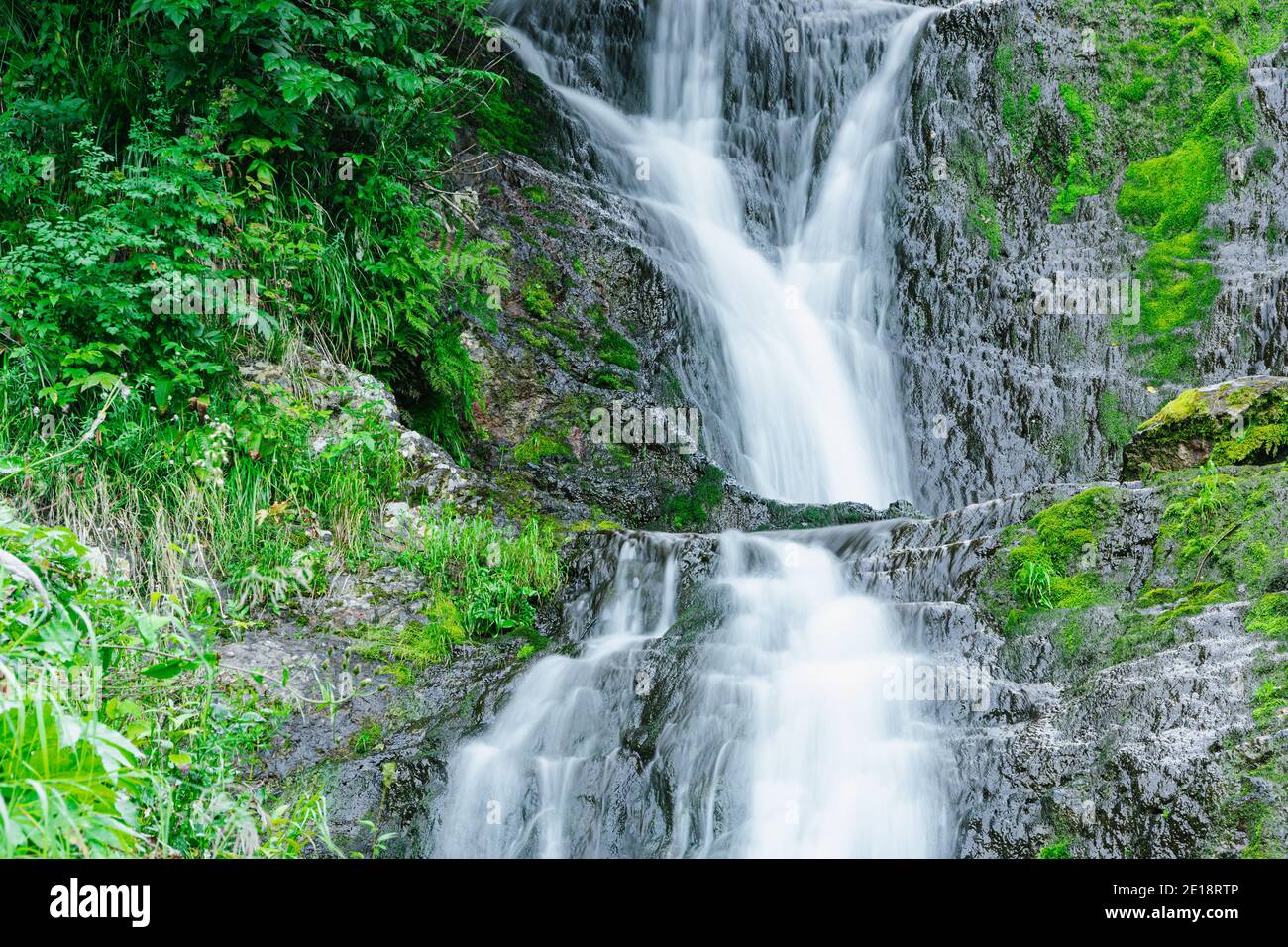 Atmospheric view of waterfall on river in rainforest. Swift stream ...
