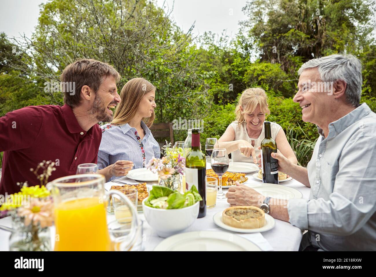 Happy family having meal Stock Photo - Alamy